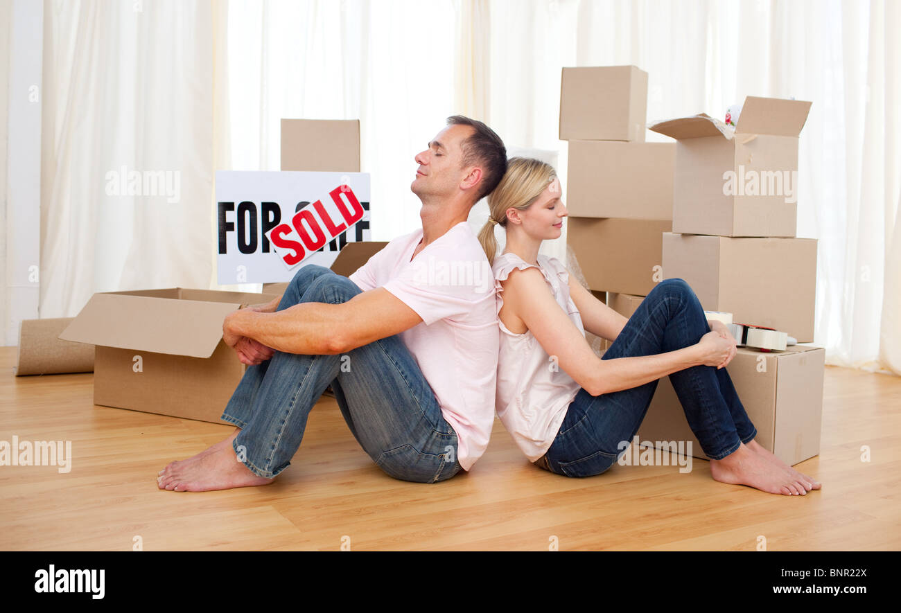 Tired couple relaxing sitting on the floor Stock Photo - Alamy