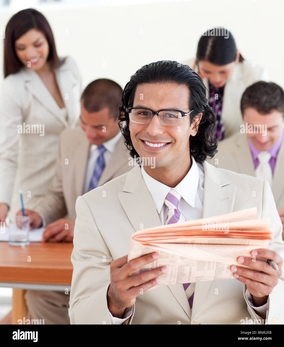 Smiling manager reading a newspaper Stock Photo - Alamy