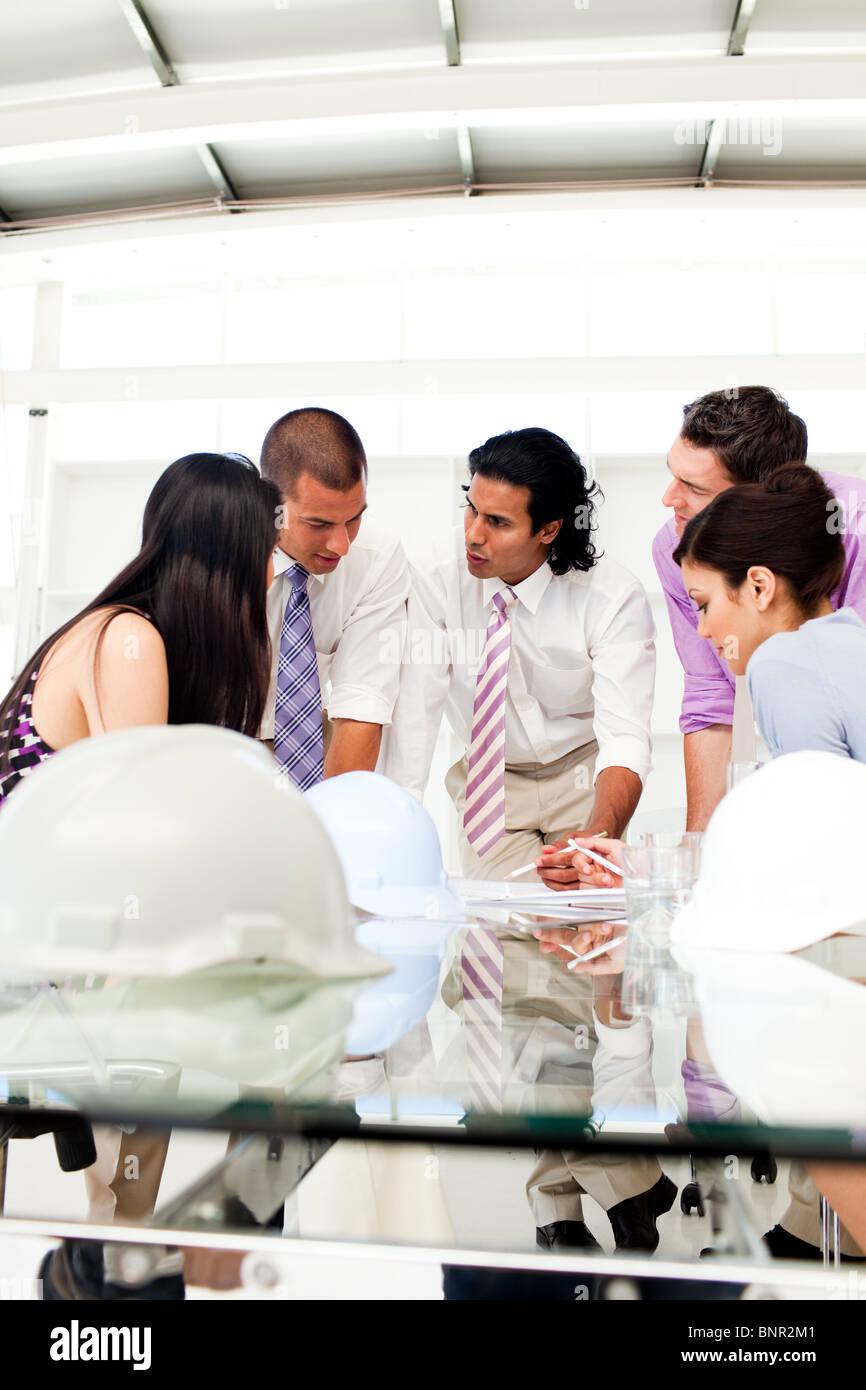 A group of engineers and their manager discussing blueprints Stock ...