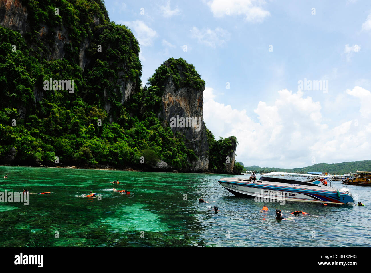 tourist boat with tourists swimming and snorkelling , maya bay , koh phi phi leh , phi phi ...