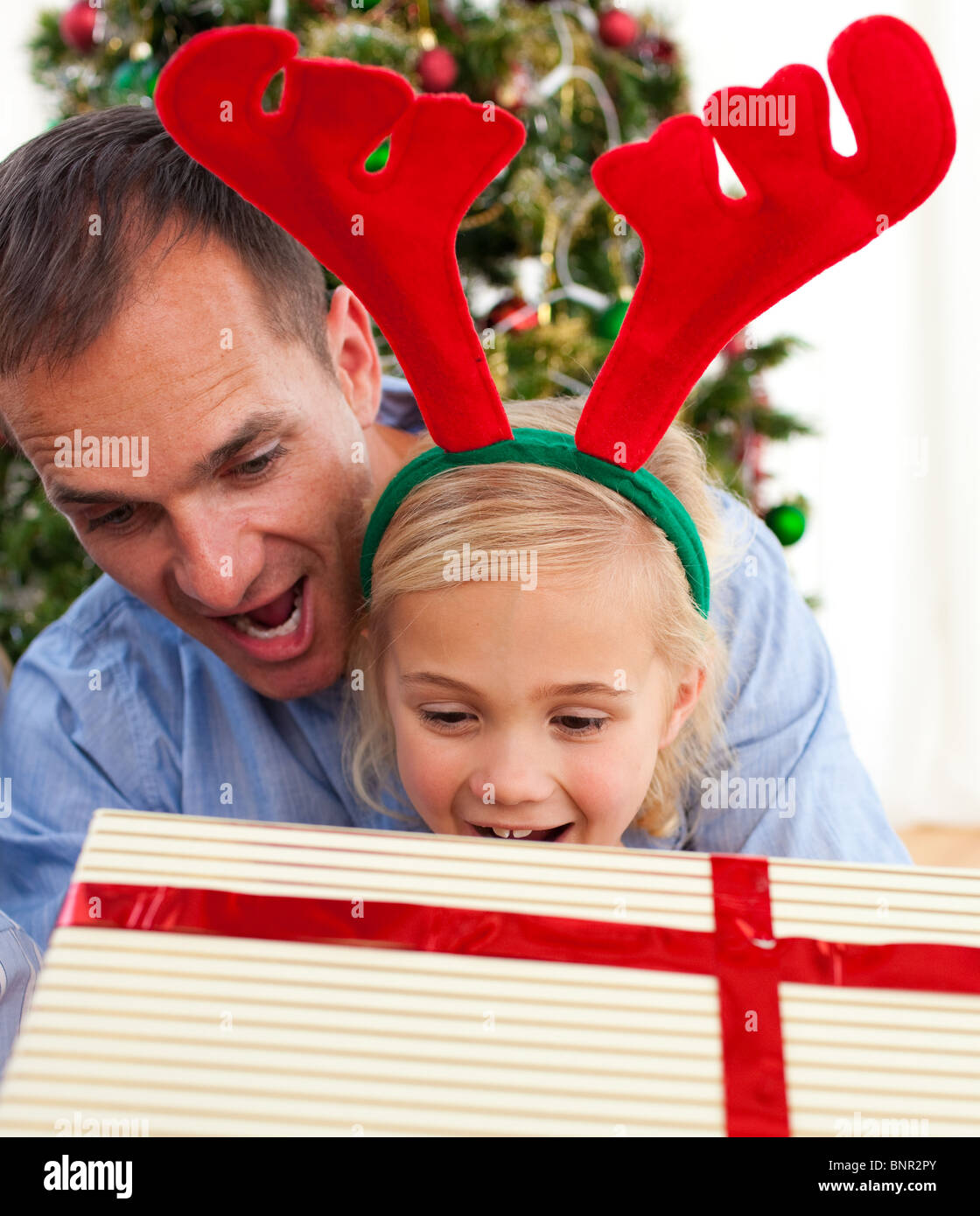 Father and his daughter opening Christmas gifts Stock Photo - Alamy