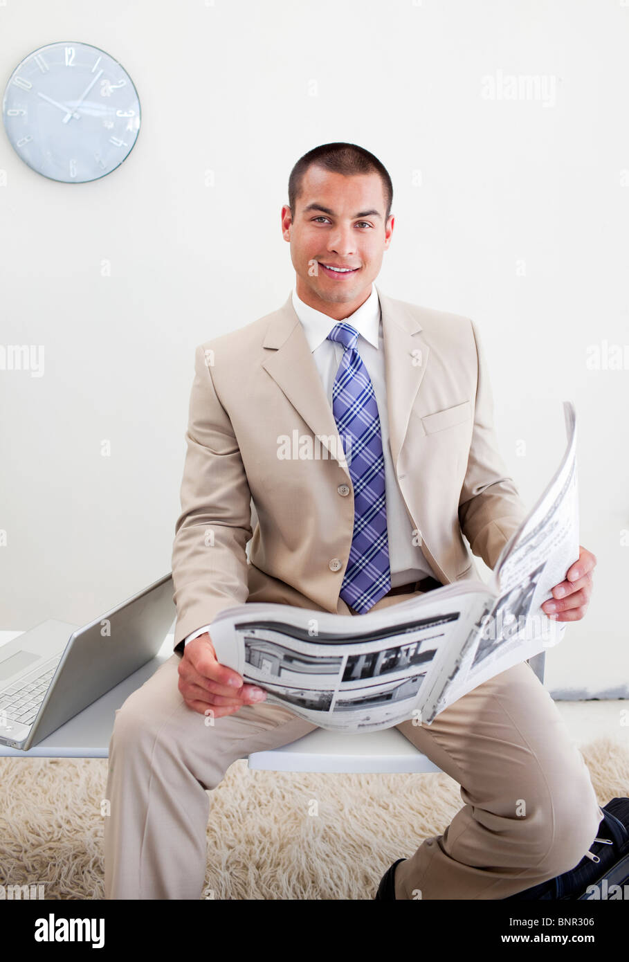 Charming manager reading a newspaper Stock Photo - Alamy