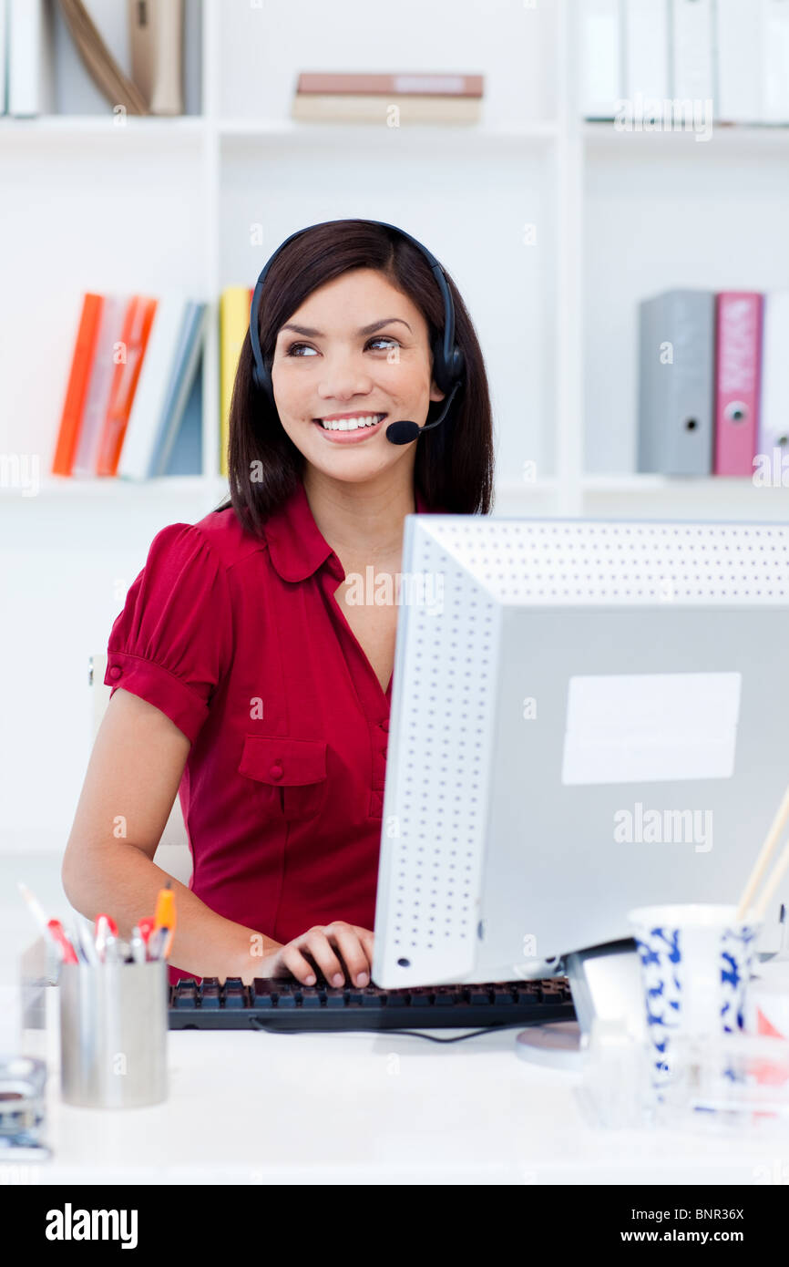 Confident female executive with headset on at her desk Stock Photo - Alamy