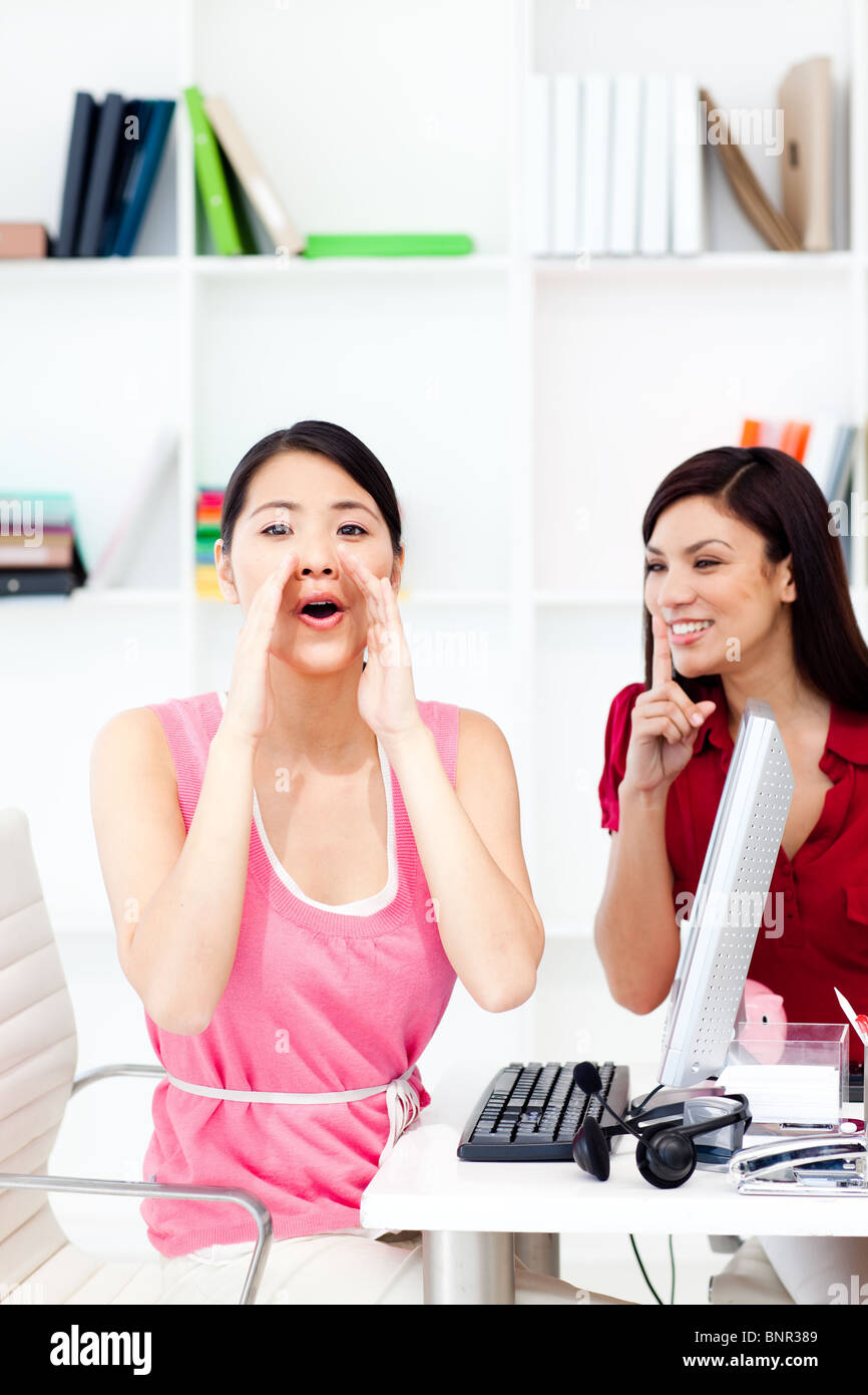 One businesswoman yelling and one businesswoman asking for silence ...