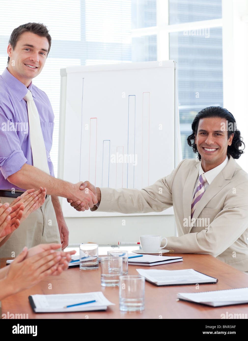 Two businessmen having a handshake Stock Photo - Alamy
