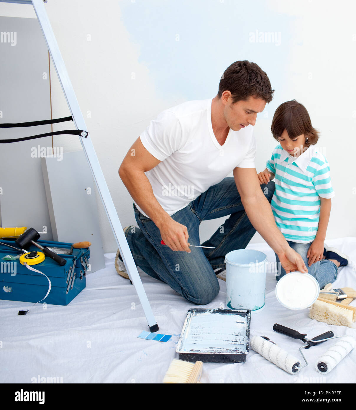 Father and his son painting in their new house Stock Photo - Alamy