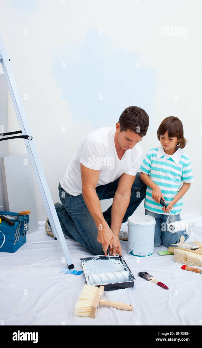 Lively Father and his son painting in their new house Stock Photo - Alamy