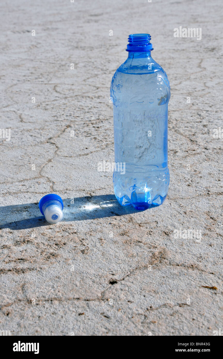 Bottle of water in desert Stock Photo - Alamy