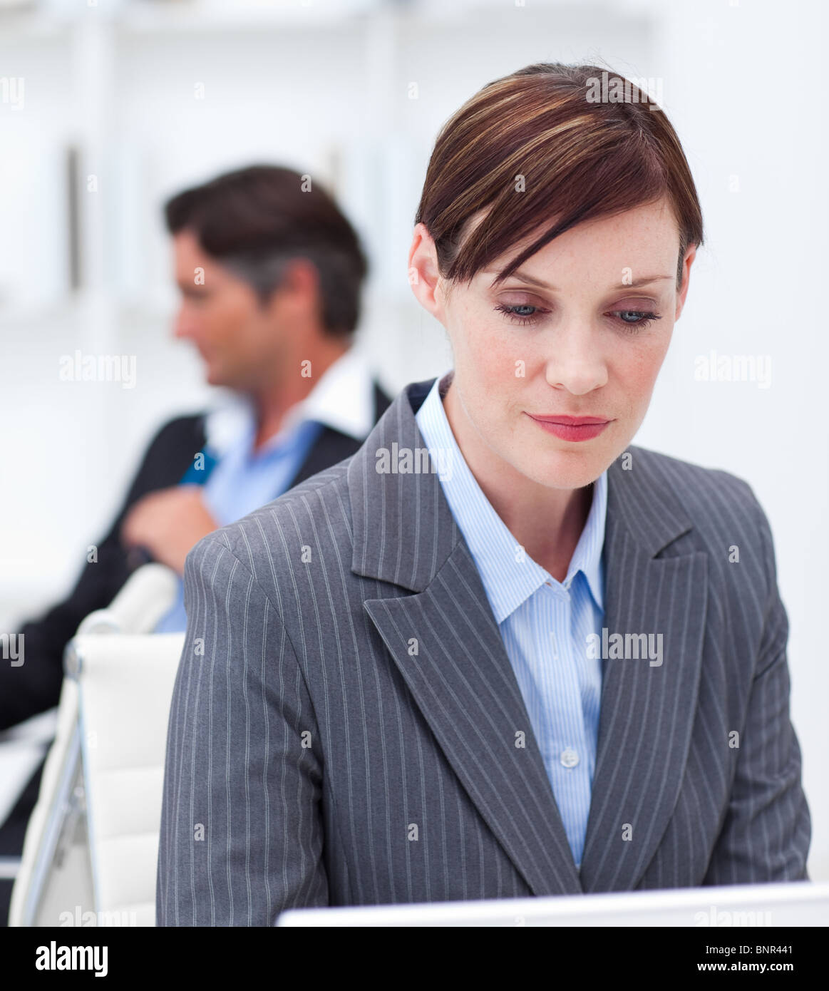 Concentrated businesswoman sitting at office desk Stock Photo - Alamy