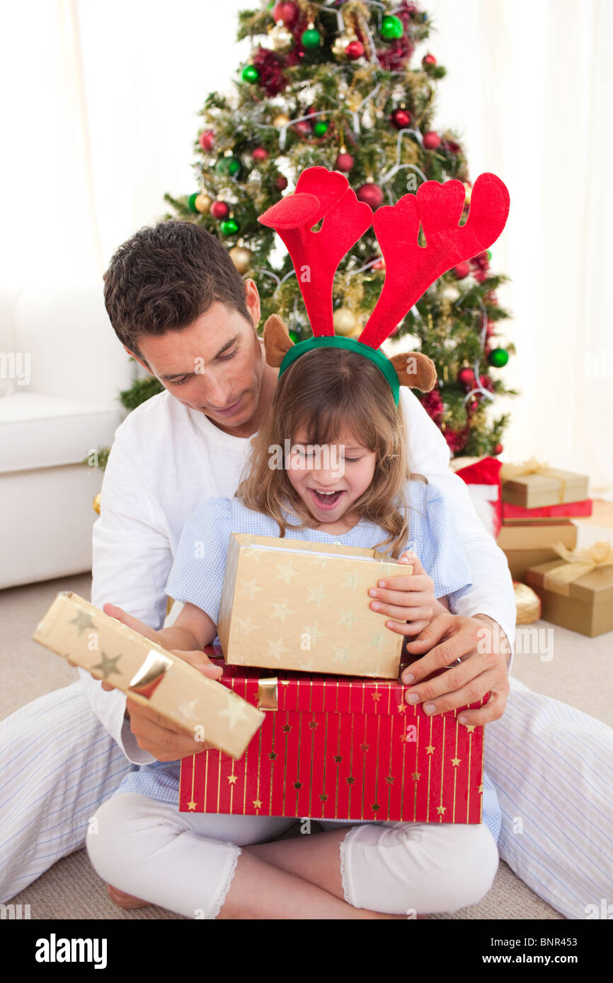 Happy father and his daughter opening Christmas gifts Stock Photo - Alamy