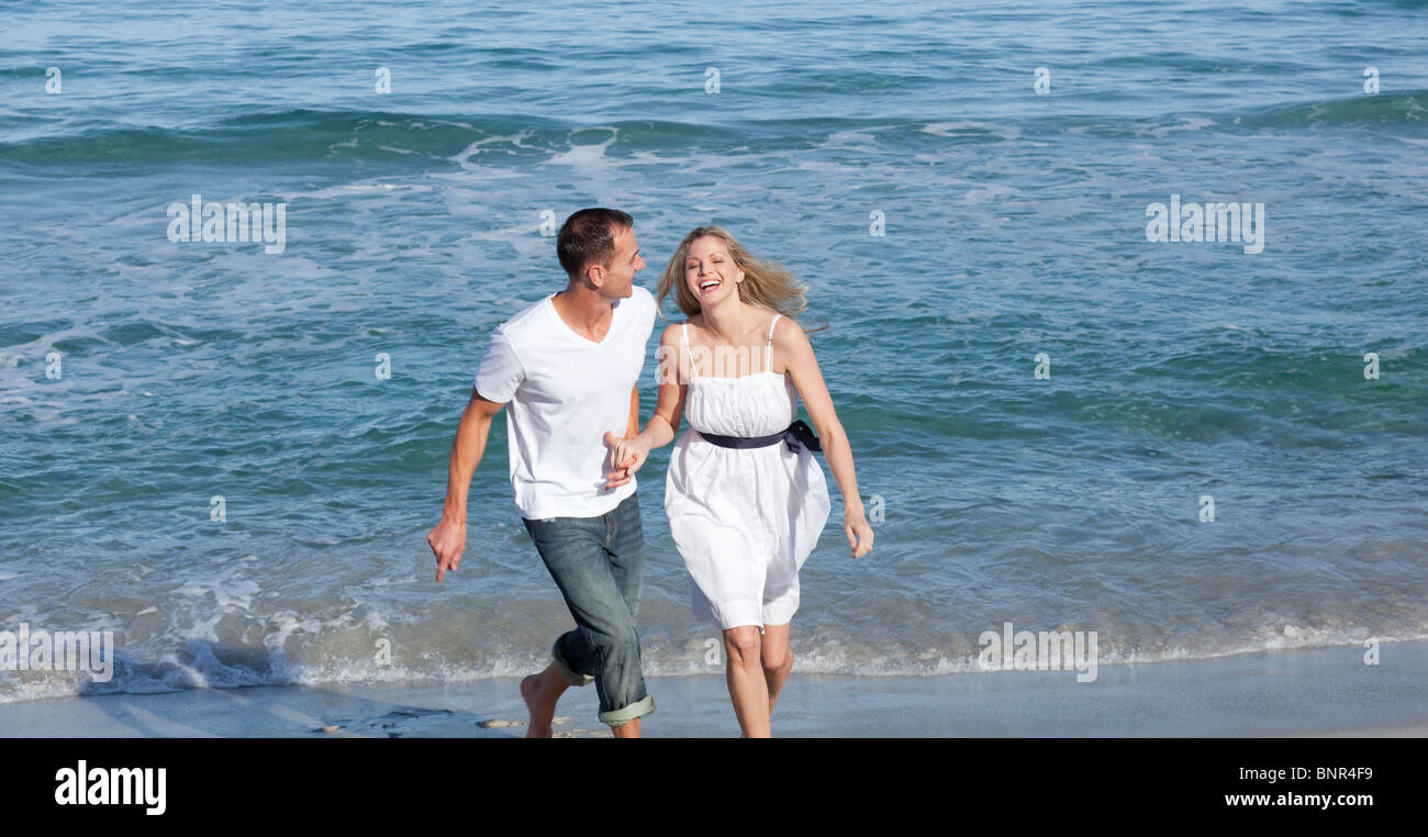 Happy lovers having fun at the seaside Stock Photo - Alamy