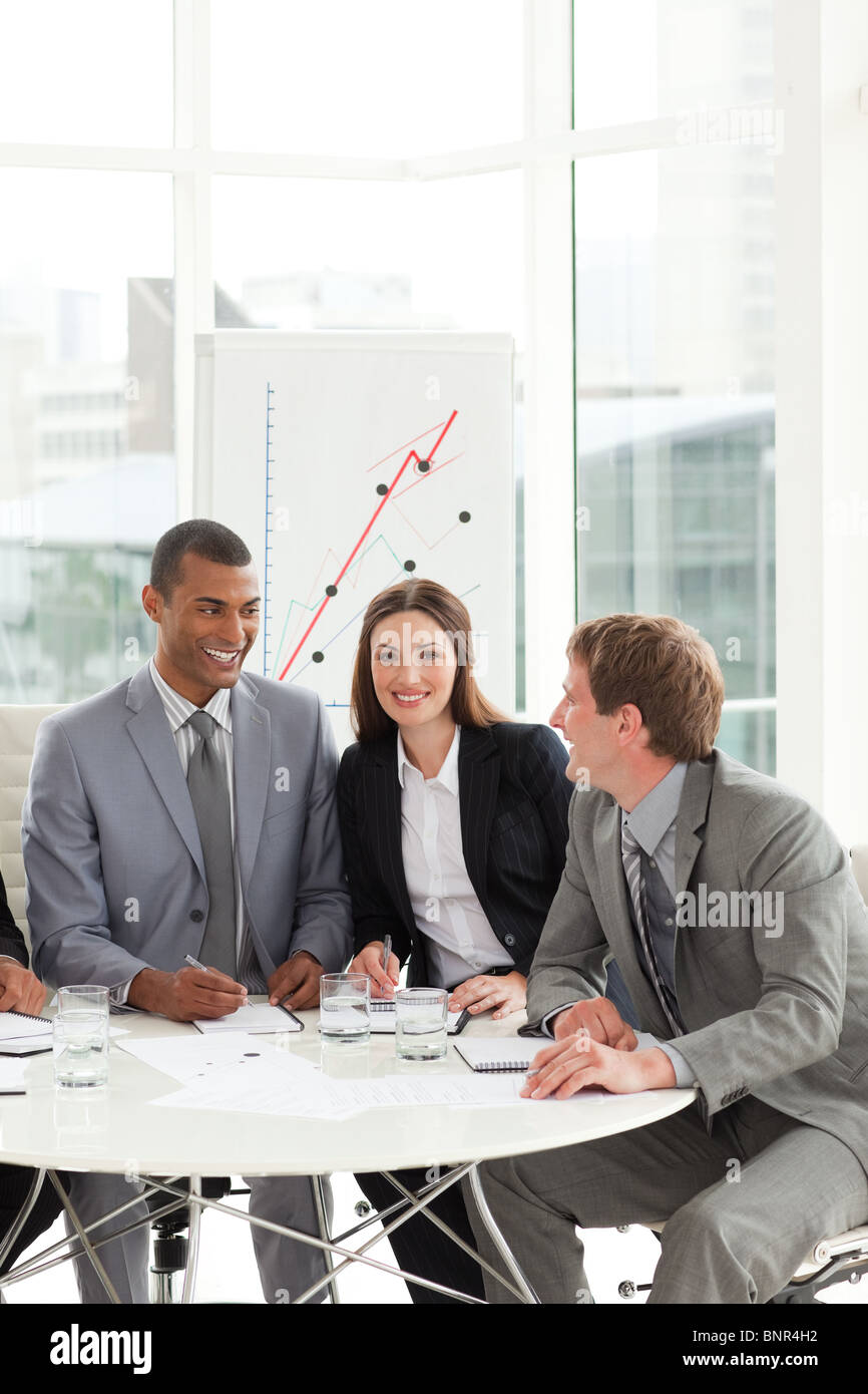 International co-workers sitting at a conference table Stock Photo - Alamy