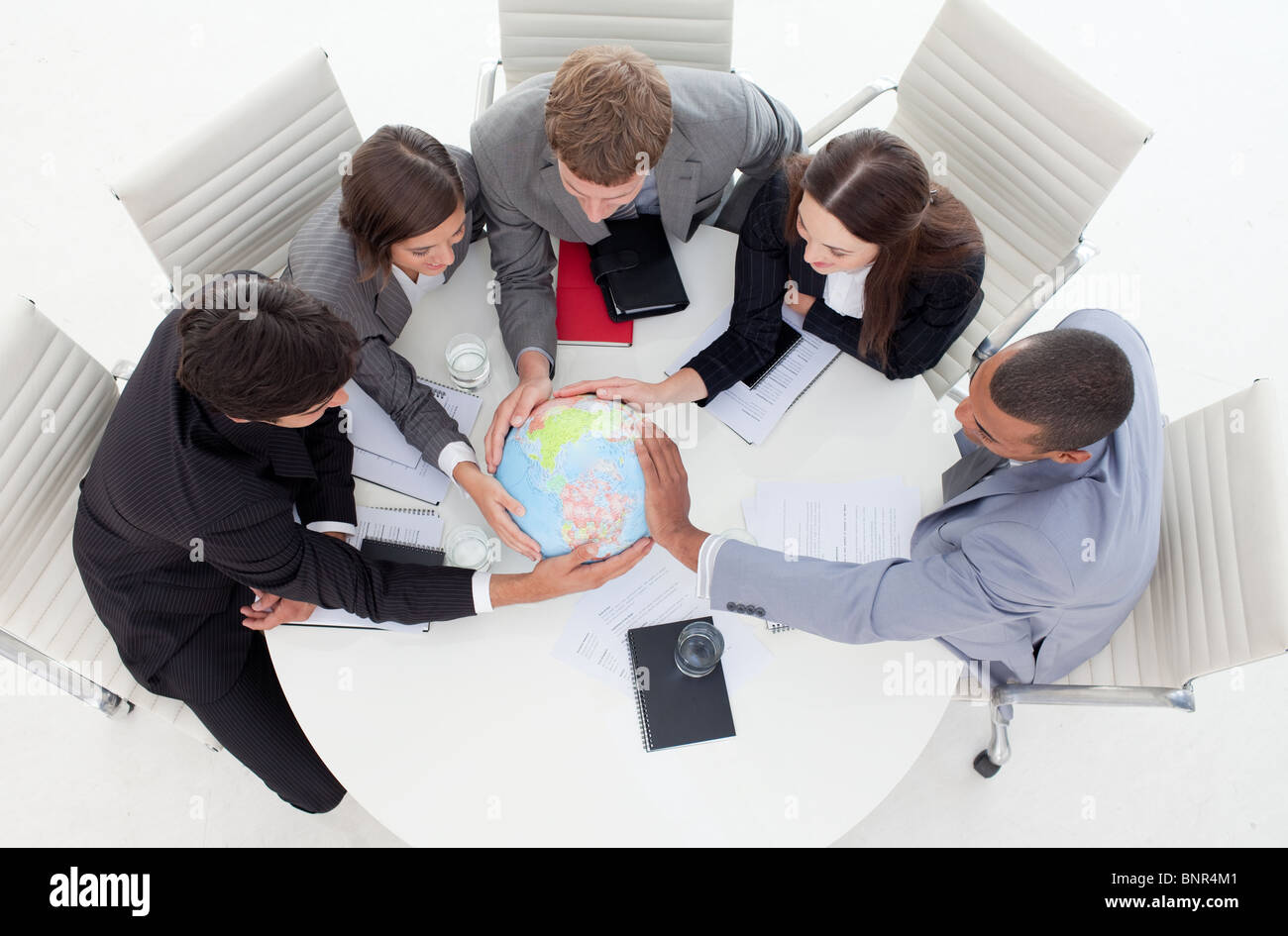 High angle of a business people holding a terrestrial globe Stock Photo ...