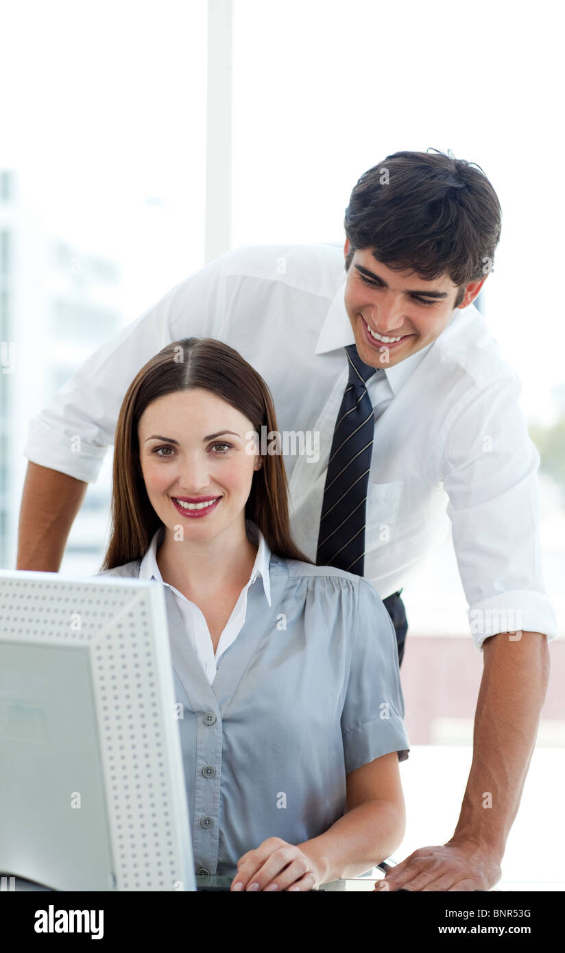 Attractive Co-workers at a computer Stock Photo - Alamy