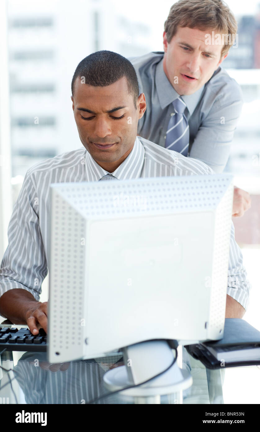 Concentrated businessmen at a computer Stock Photo - Alamy