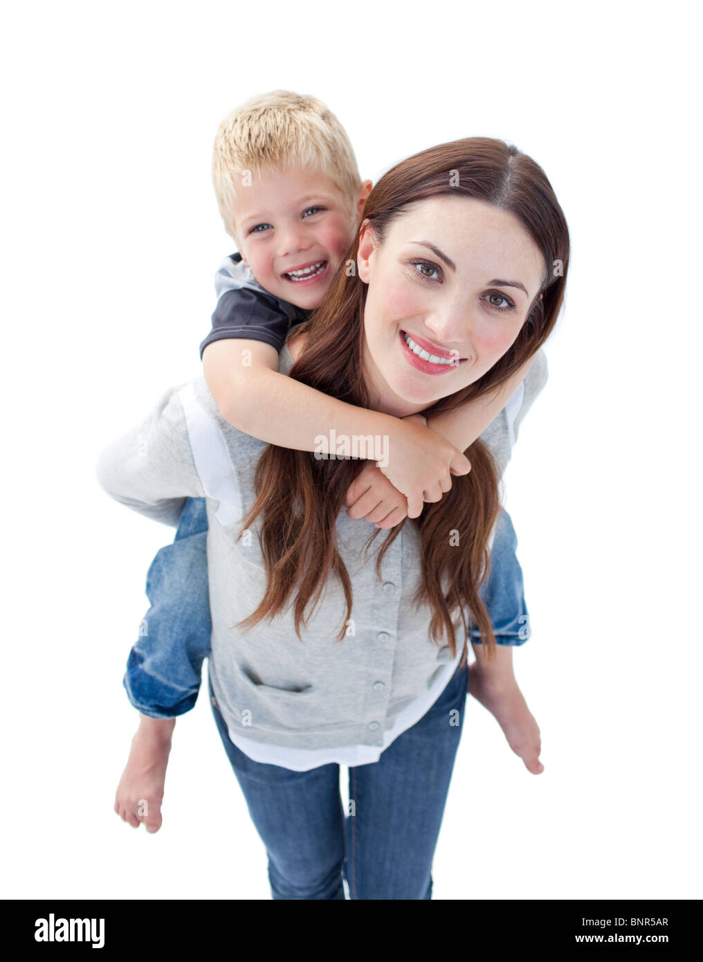 Close-up of brunette mother giving her son piggyback ride Stock Photo ...