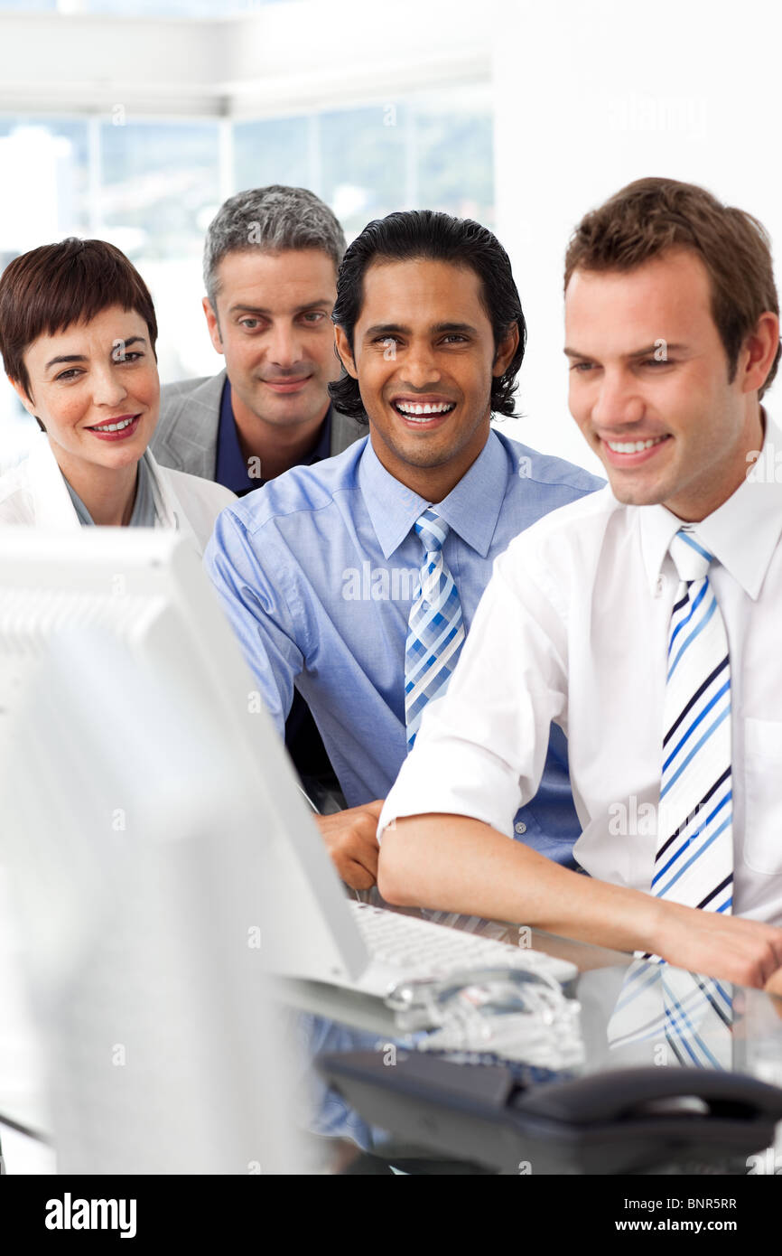 Smiling international business partners sitting together Stock Photo ...