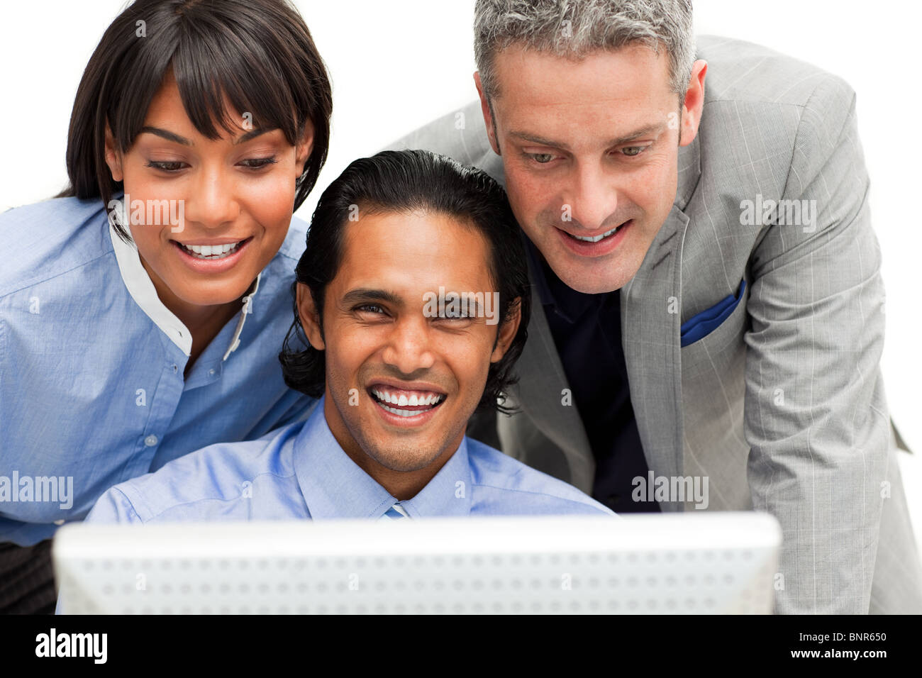Positive business group working at a computer Stock Photo - Alamy