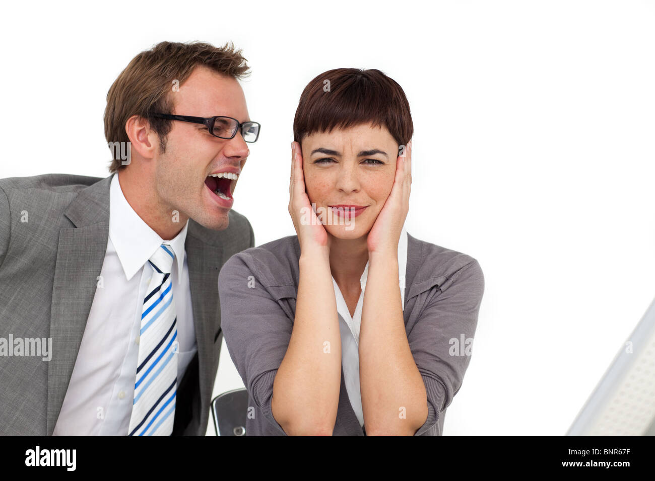Stressed businessman shouting into his colleague's ear Stock Photo - Alamy