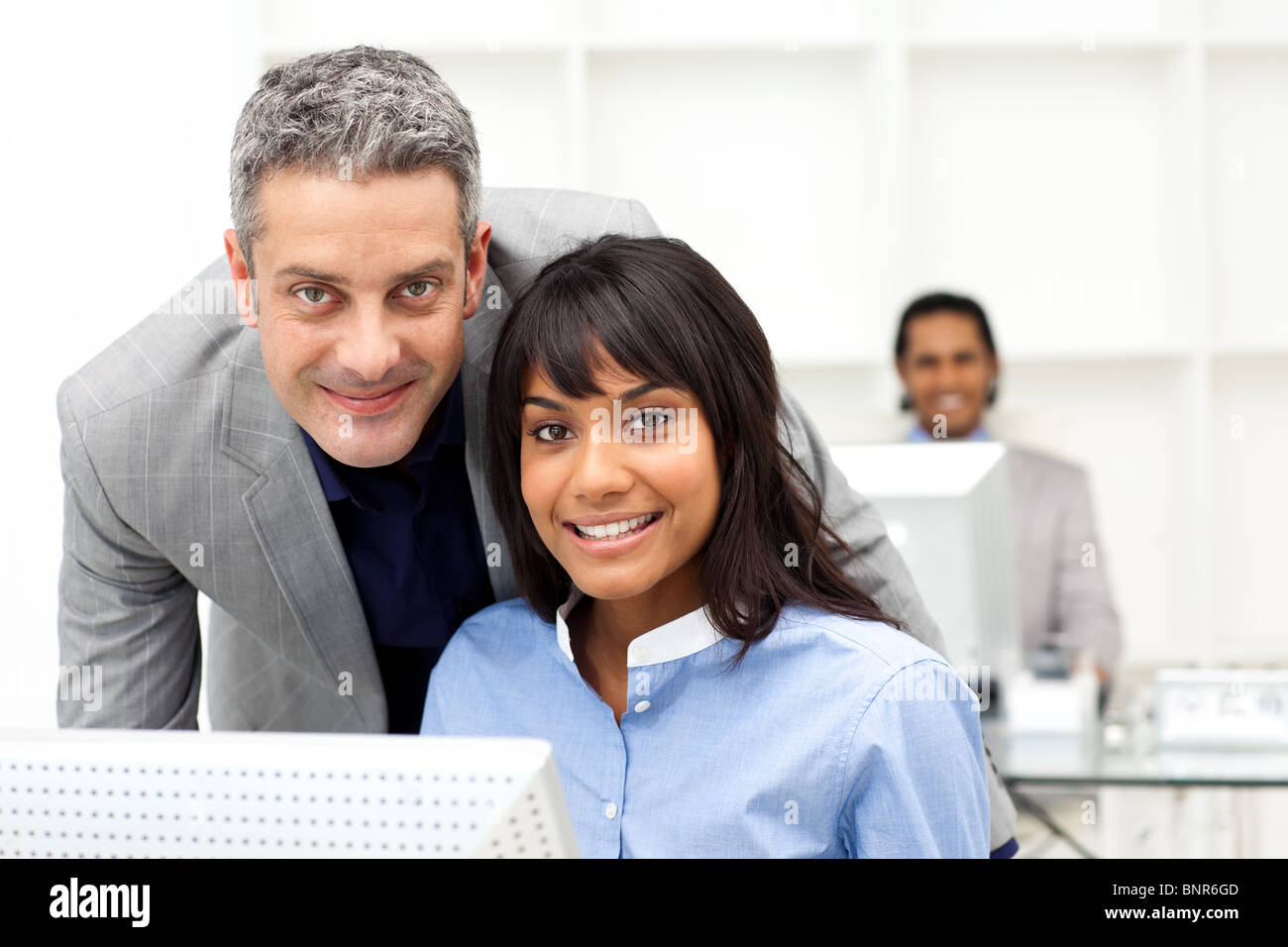Two colleagues working together at a computer Stock Photo - Alamy