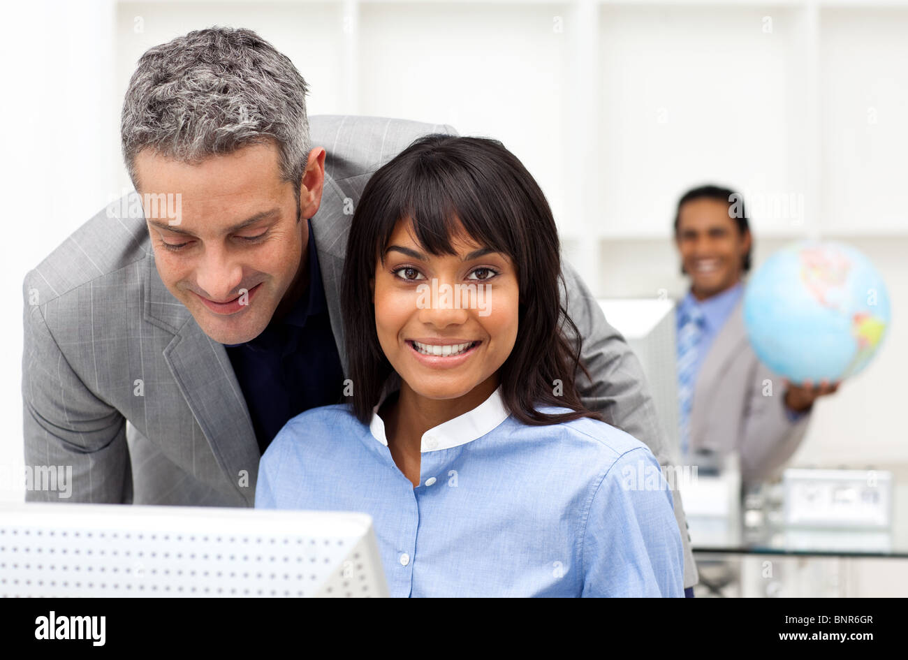 Mature businessman helping his colleague Stock Photo - Alamy