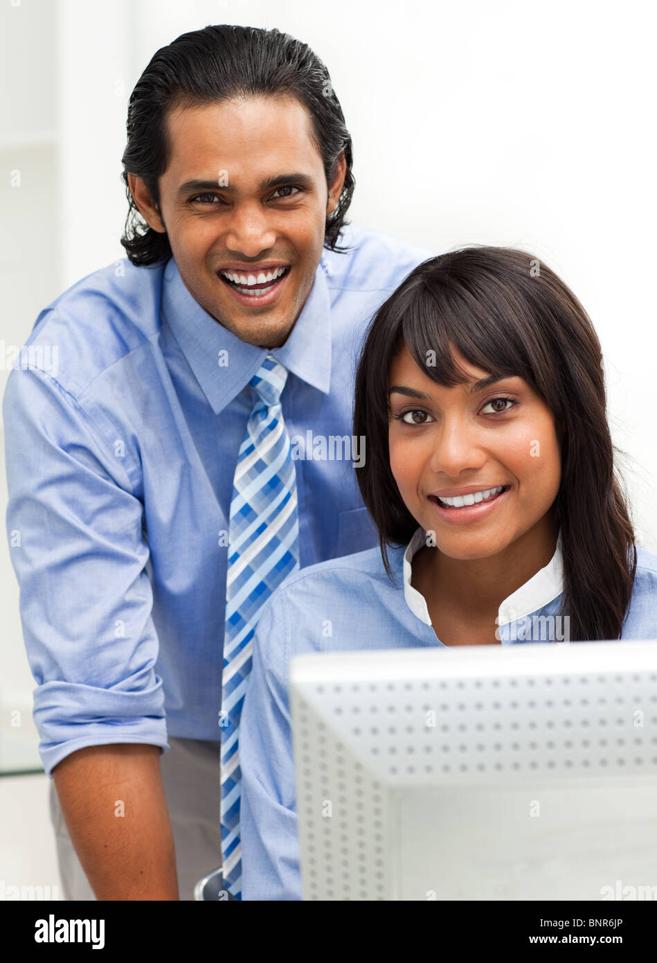 Business partners working together at a computer Stock Photo - Alamy
