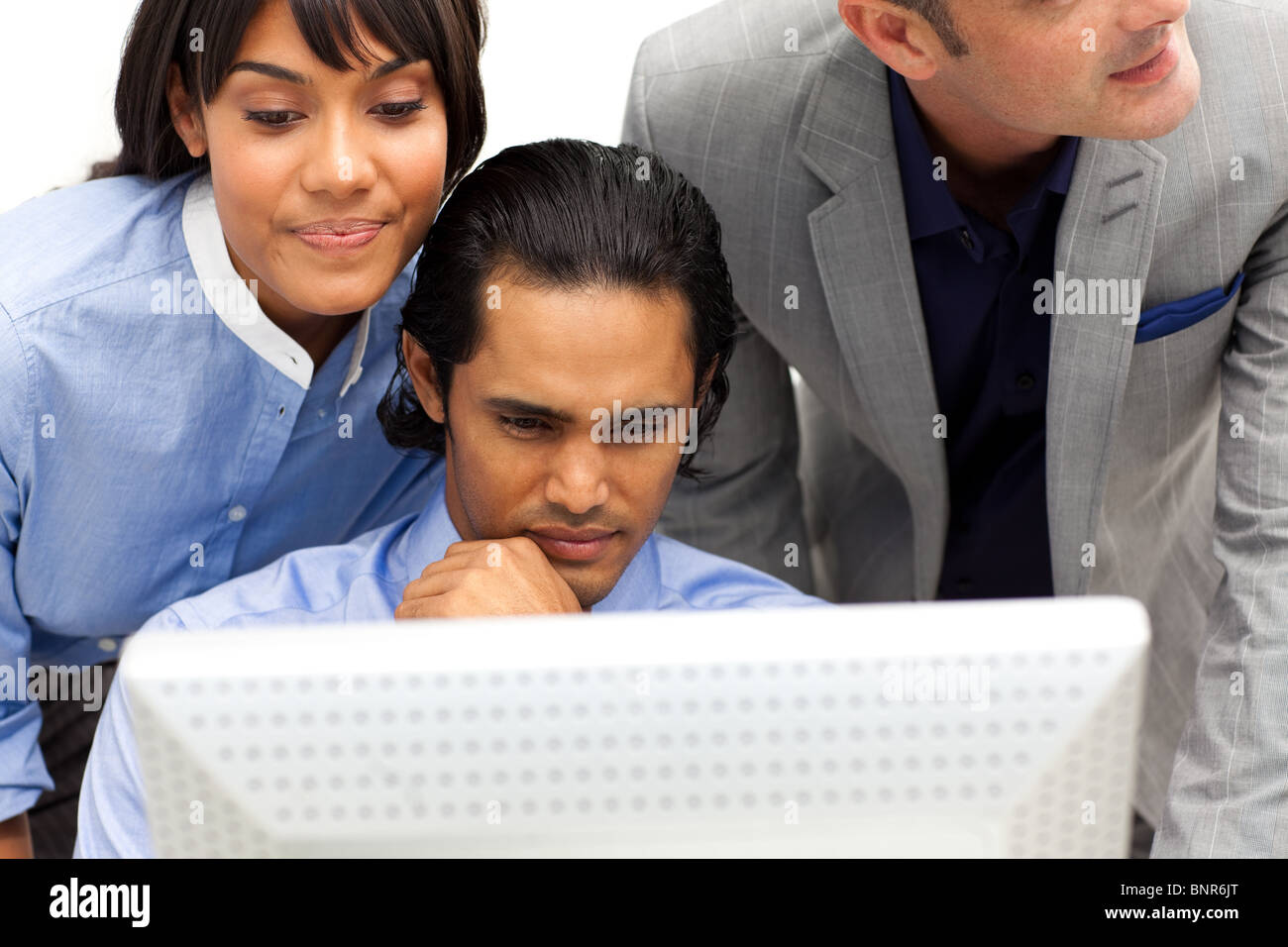 Concentrated Business partners working together Stock Photo - Alamy