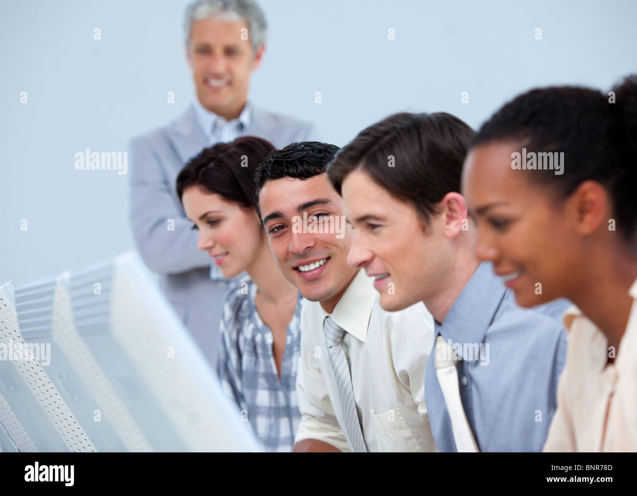 International business team at work with their manager Stock Photo - Alamy