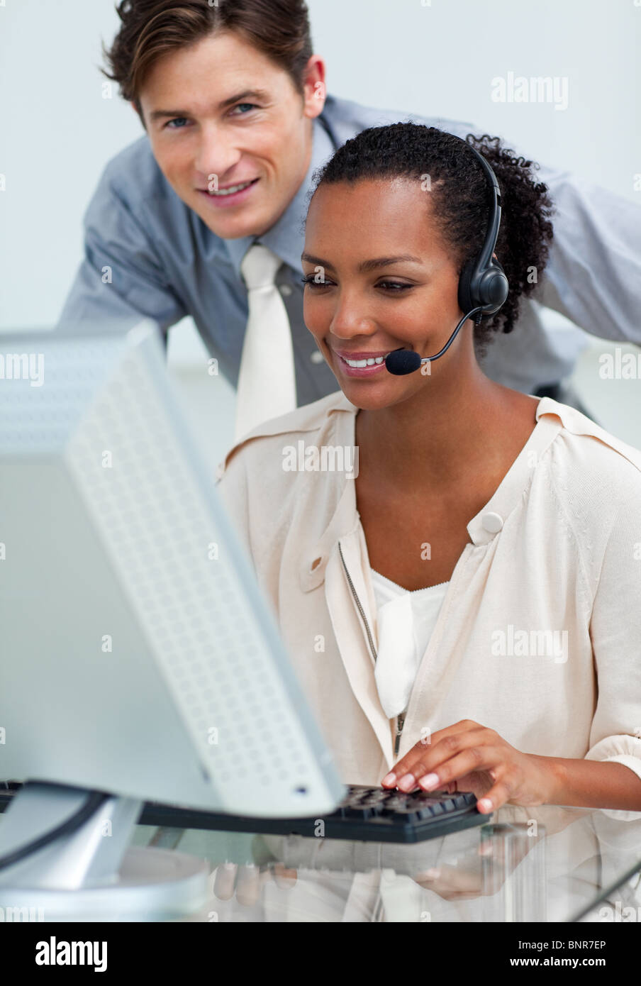 Businessman helping his colleague Stock Photo - Alamy
