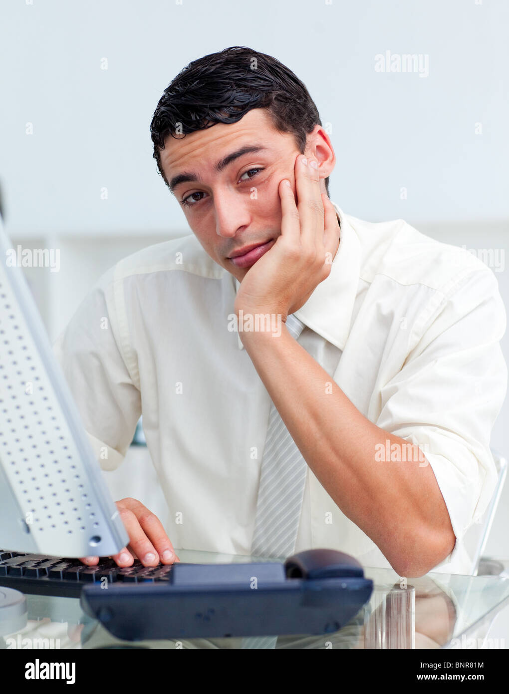 Bored businessman at his desk Stock Photo - Alamy