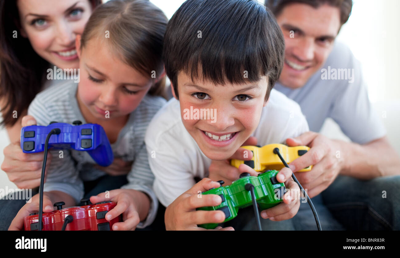 Parents playing video games with their children Stock Photo - Alamy