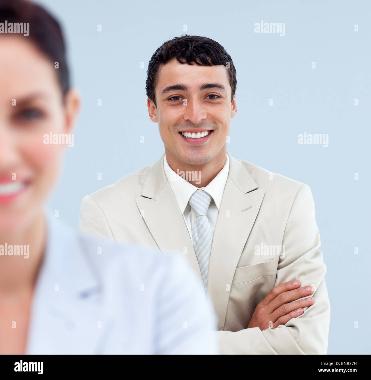 Self-assured businessman standing with folded arms Stock Photo - Alamy