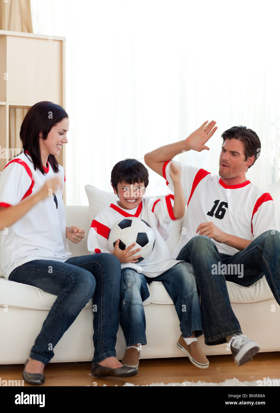 Joyful family watching football match Stock Photo - Alamy