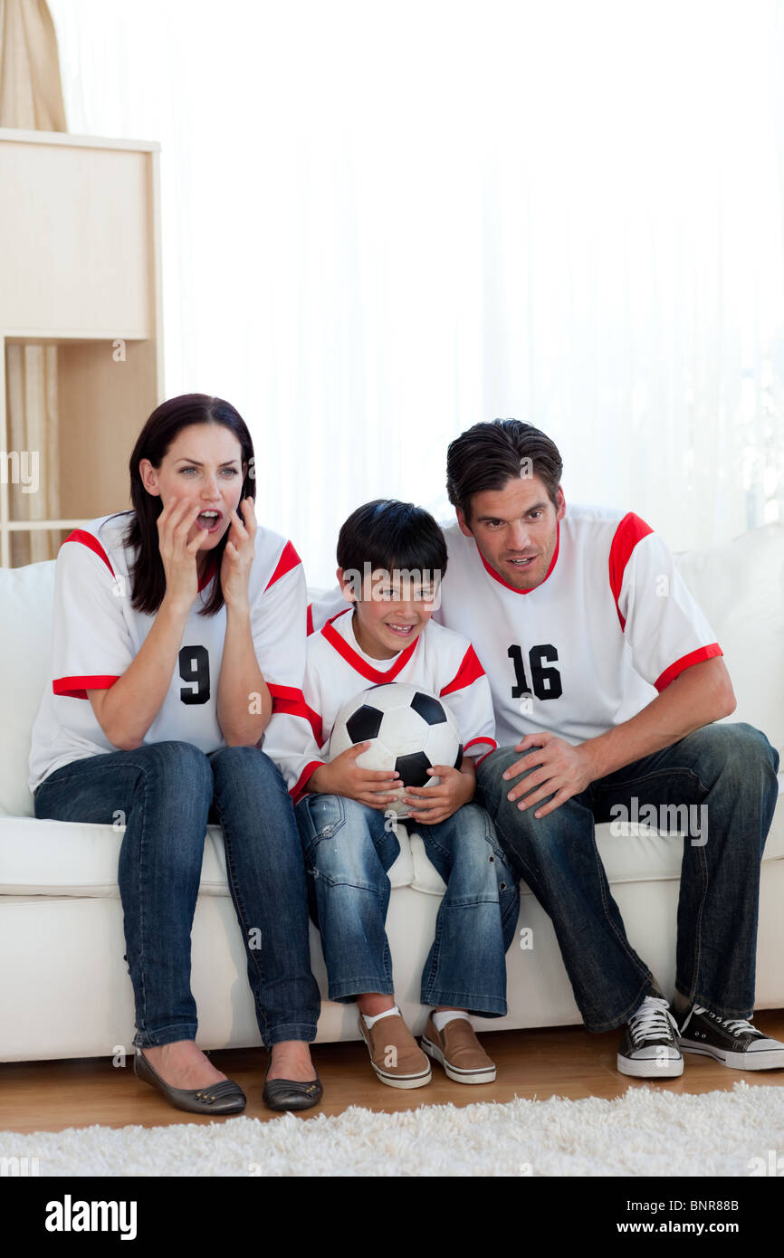Concentrated family watching football match Stock Photo - Alamy