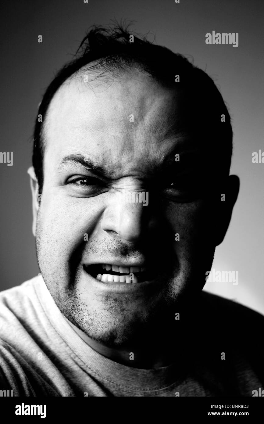 a black & white portrait of a very angry man shouting Stock Photo - Alamy