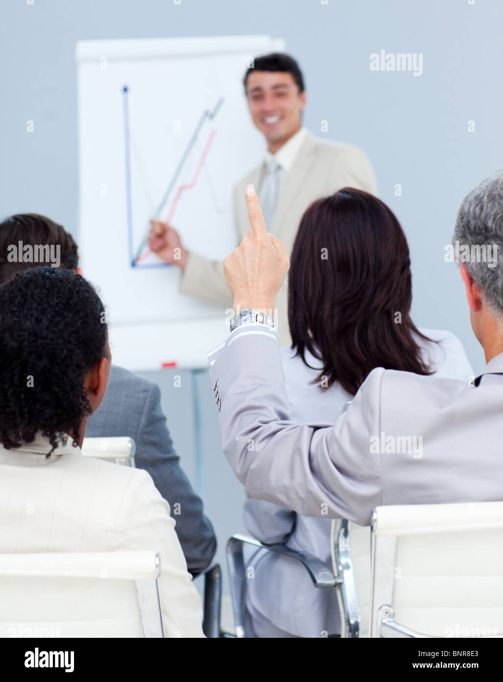Senior businessman asking a question at a presentation Stock Photo - Alamy