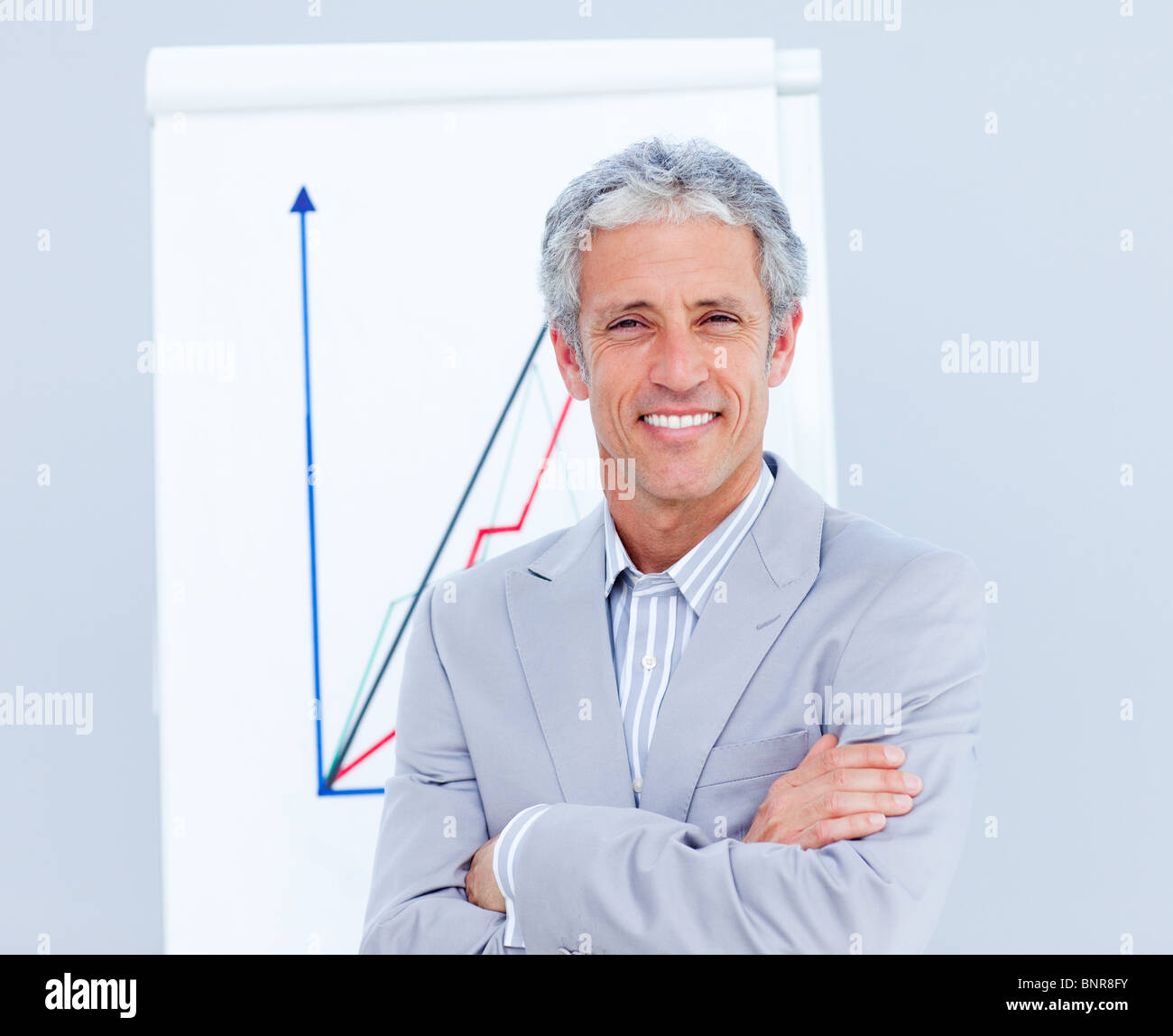 Smiling businessman giving a presentation Stock Photo - Alamy