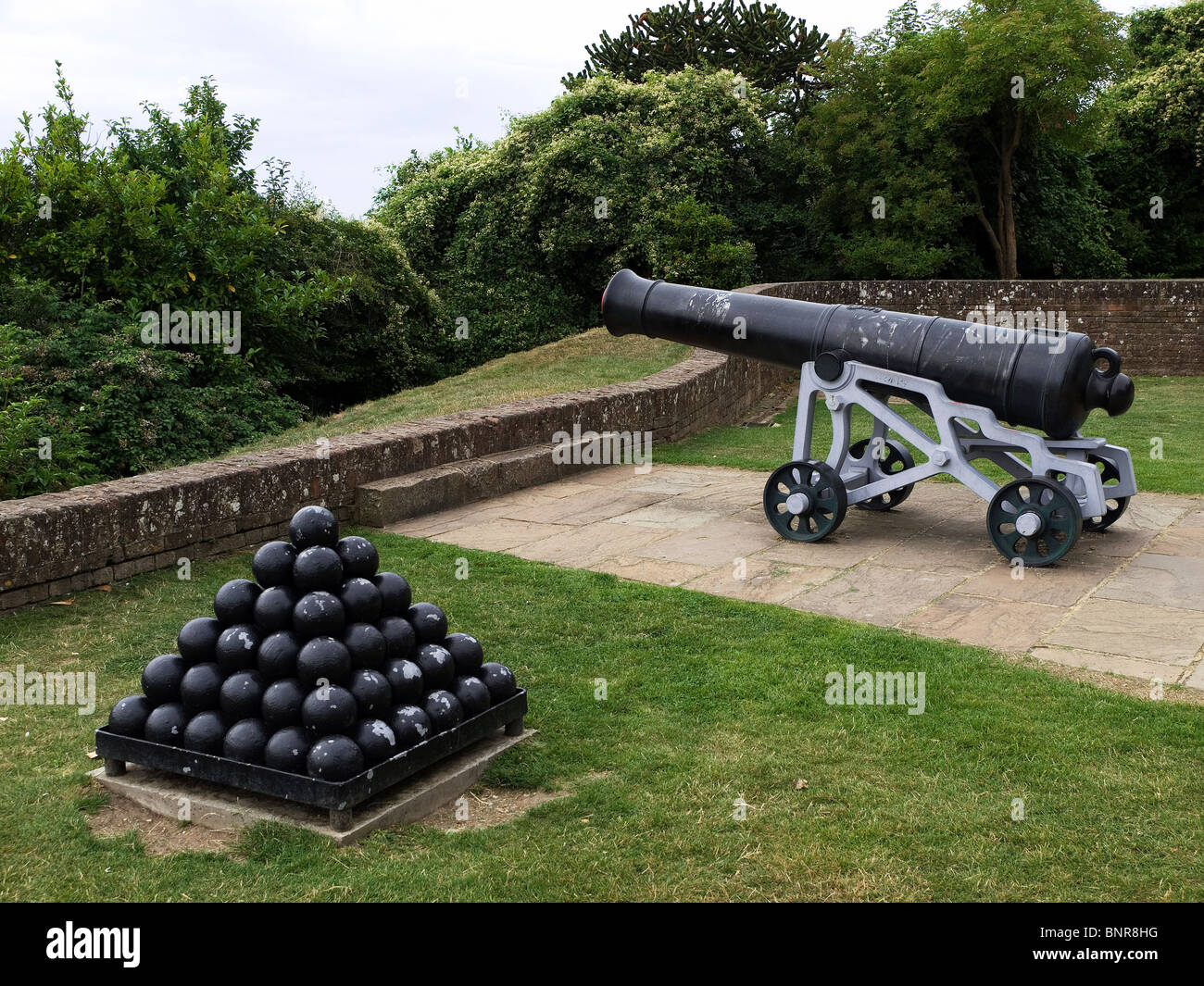 Gun and a pile of cannonballs in the Gun Garden by Ypres tower Rye East ...