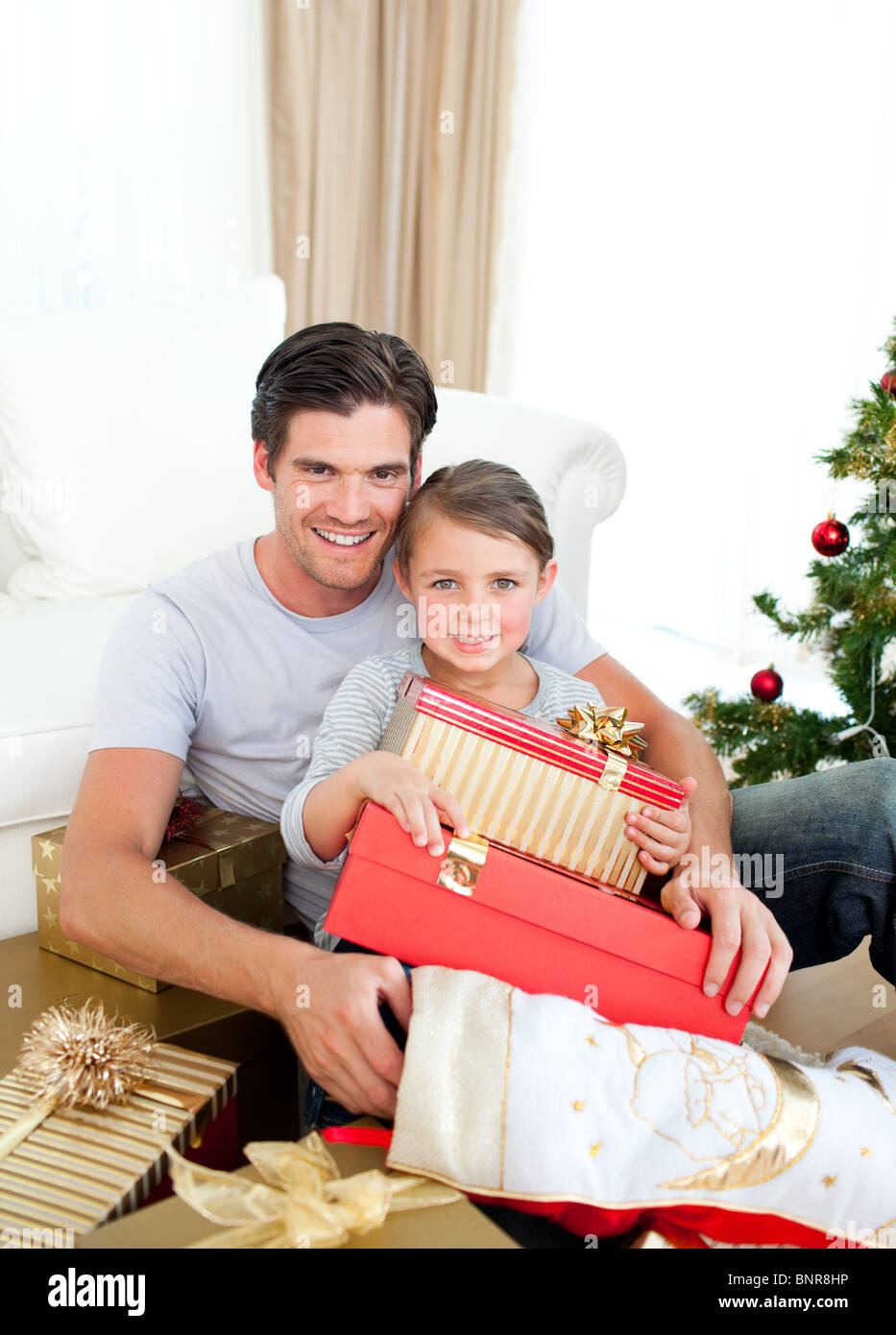 Happy little girl with her father holding a Christmas gift Stock Photo ...