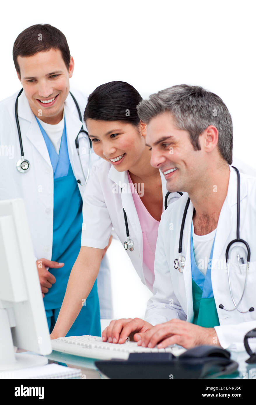 Happy doctors and nurse working at computer Stock Photo - Alamy