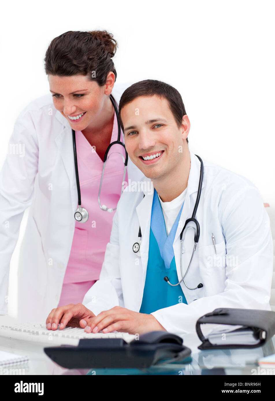 Nice doctor and nurse working at computer Stock Photo - Alamy