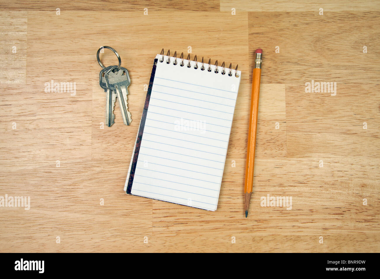 Pad of Paper, Pencil and Keys on a Wood Background Stock Photo - Alamy