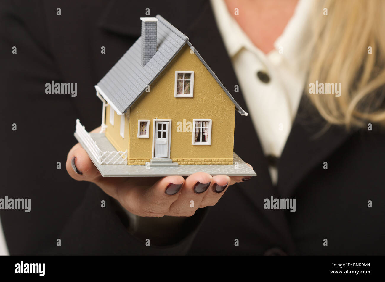 Female hand holding small house Stock Photo - Alamy