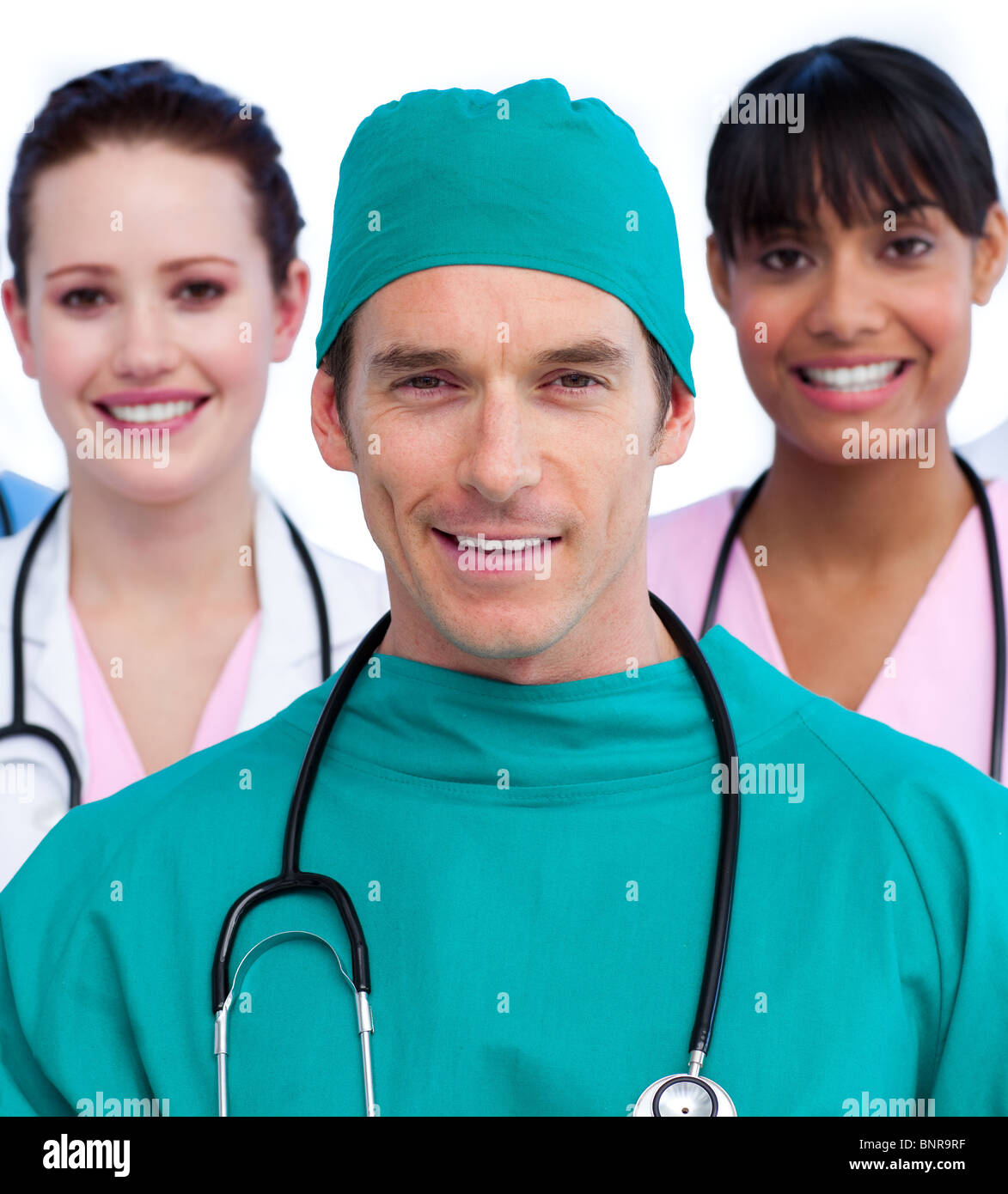 Smiling surgeon with female nurses Stock Photo - Alamy