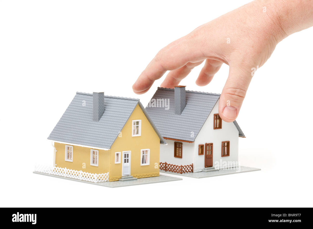 Man's hand reaching for house isolated on a white background Stock ...