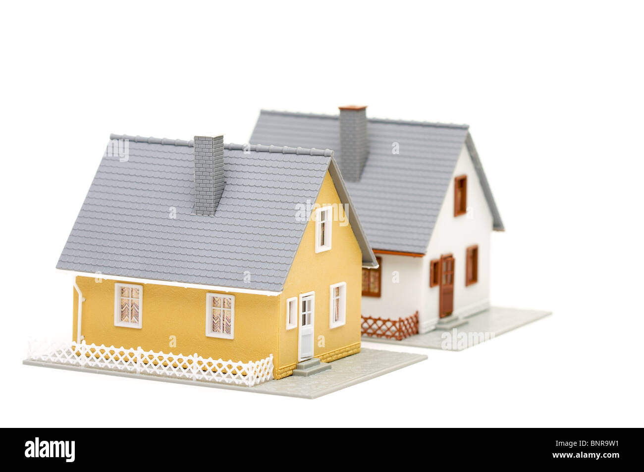 Pair of small houses isolated on a white background Stock Photo - Alamy