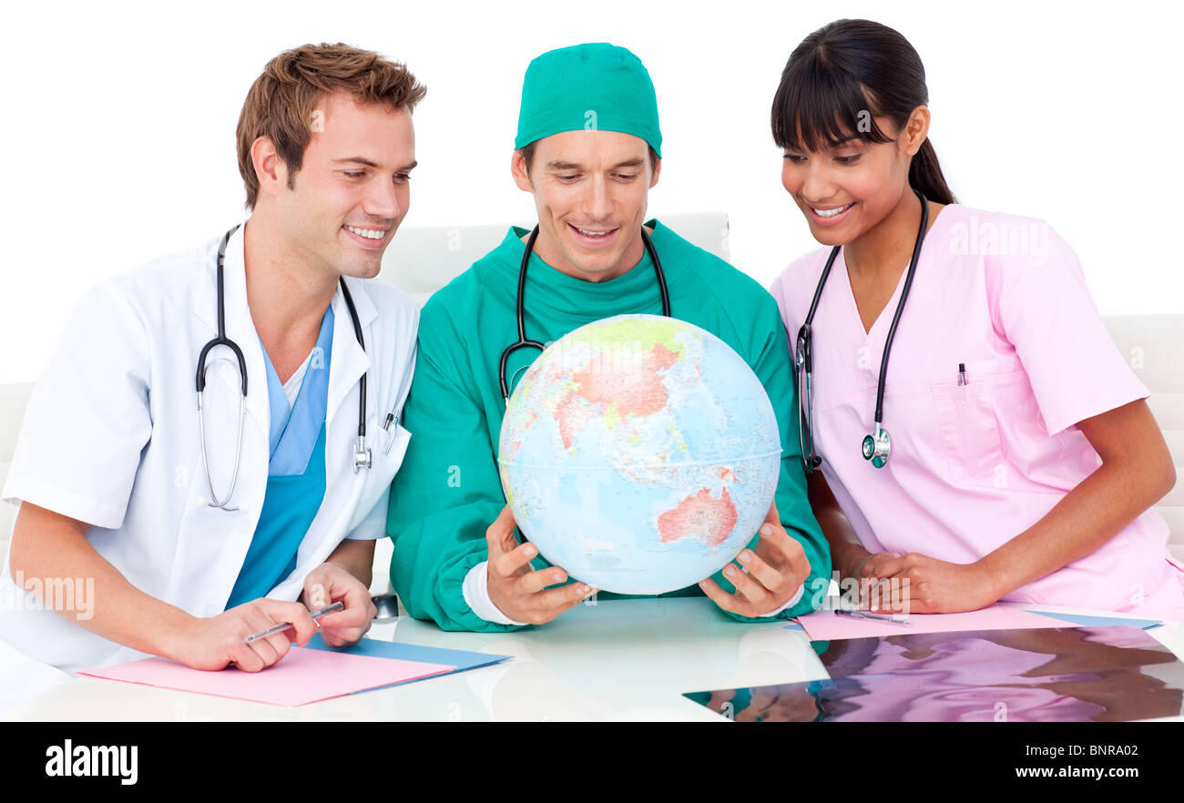 Medical staff with a globe Stock Photo - Alamy