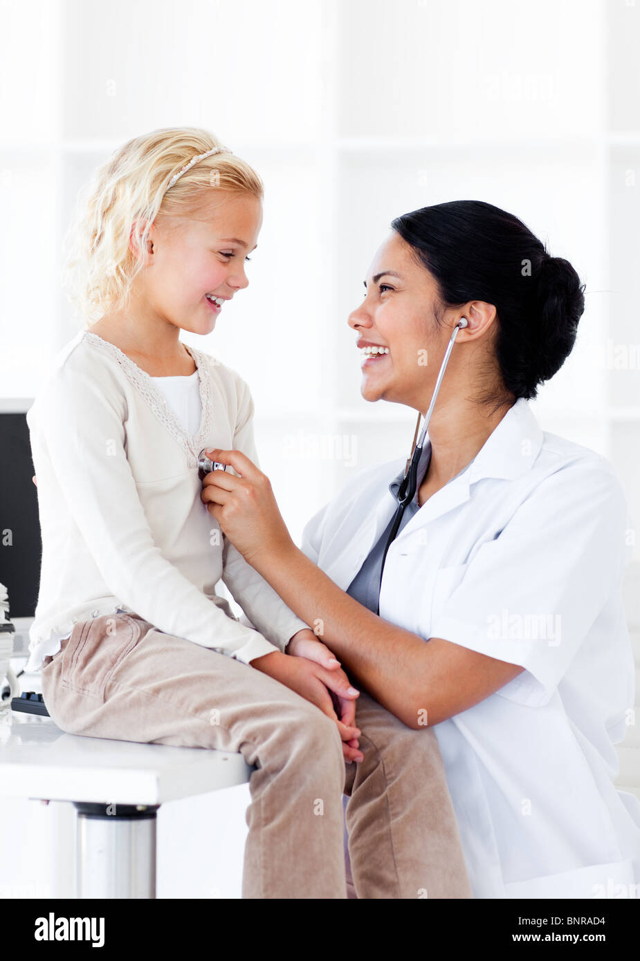 Smiling little girl attending a medical check-up Stock Photo - Alamy