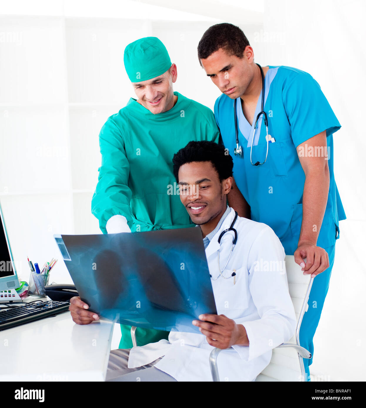 Positive male doctors looking at X-Ray Stock Photo - Alamy