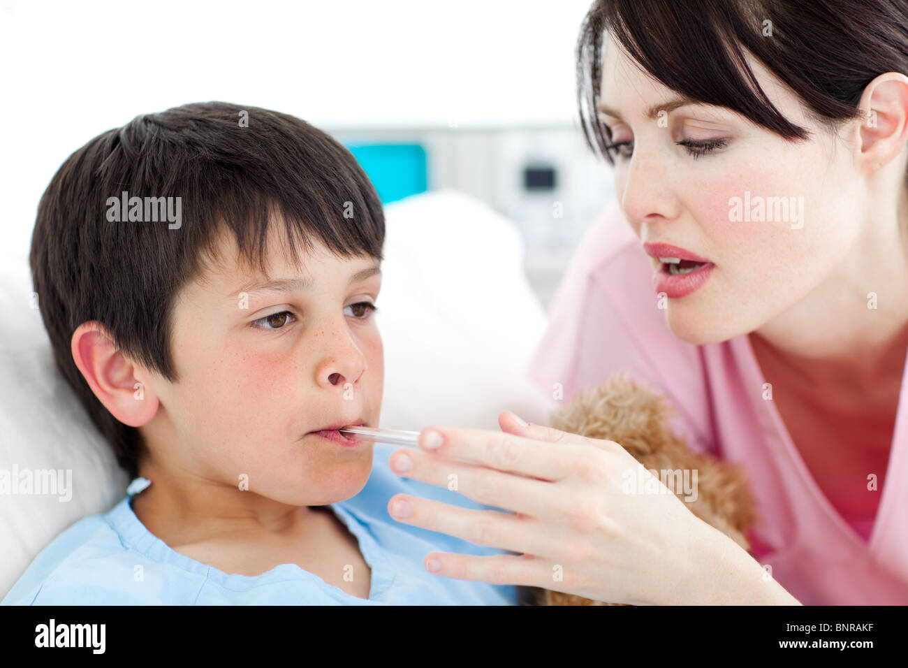 Caring nurse taking her patient's temperature Stock Photo - Alamy